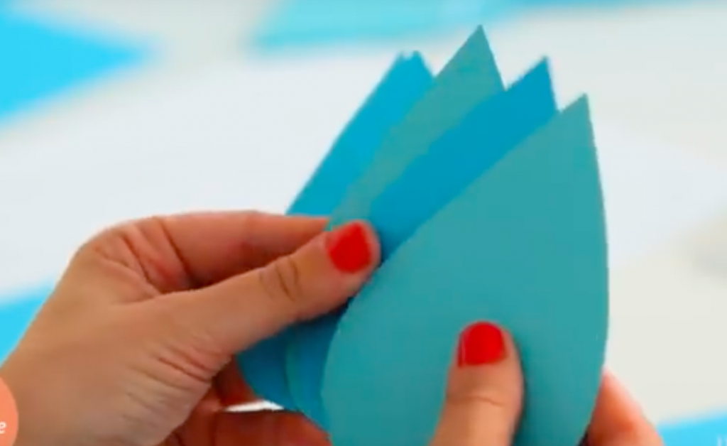 First She Cuts Out Tear-Drop Shapes Then She Puts Them Together To Make ...